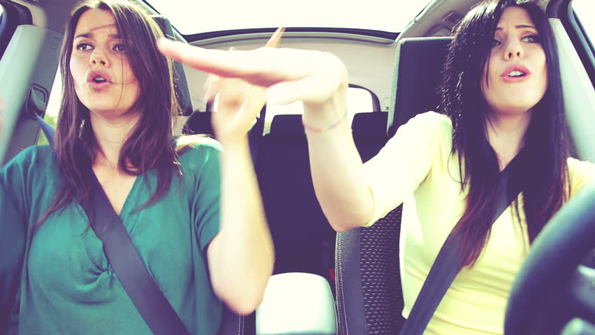 Two Beautiful Women Singing And Dancing Driving Car Stock Footage Video