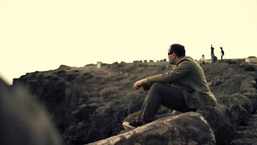 Sad, Depressed Man Sitting On Rocks By The Sea Stock Footage Video ...