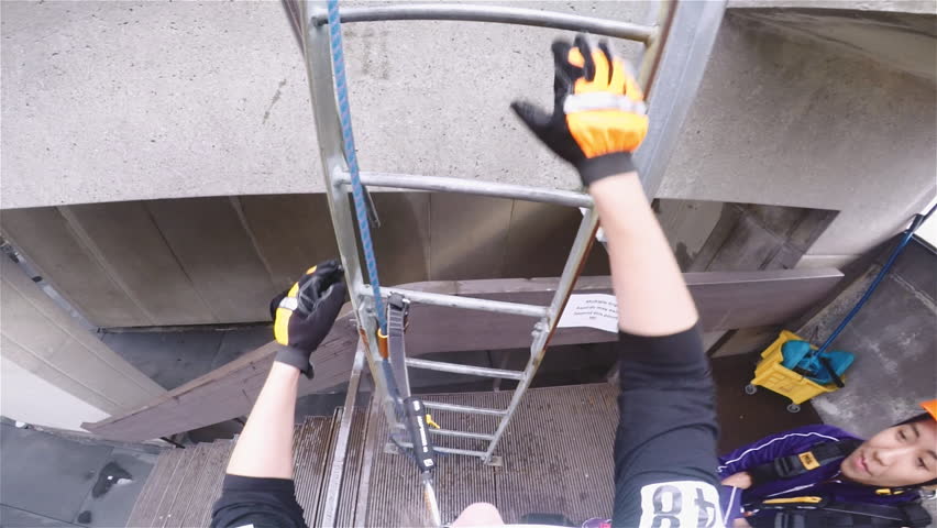 A Man Wearing A Tool Belt Full Of Tools Steps Up Onto A Ladder To Begin ...