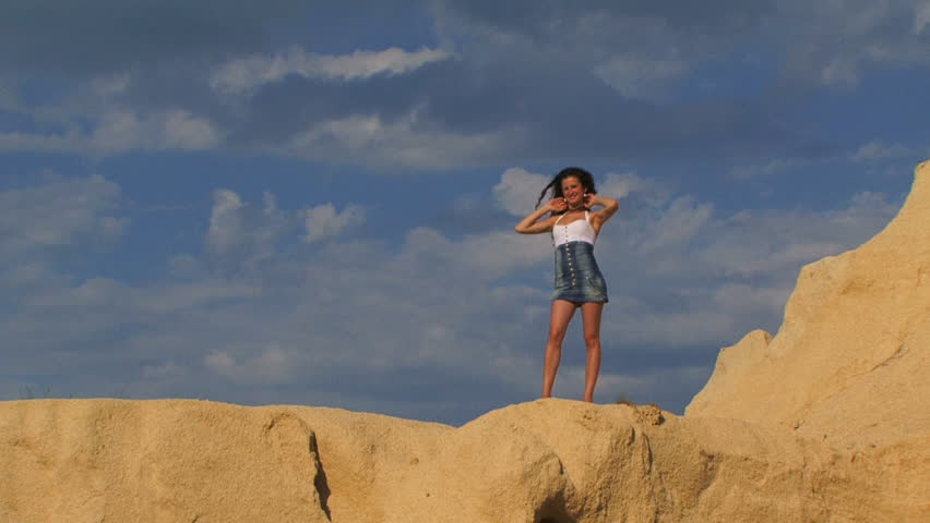 Kiss From A Height. Beautiful Girl Standing On The Edge Of The Cliff ...