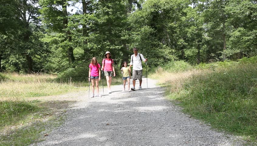 3 Happy Friends Walk Down Path Through Park Toward Camera Stock Footage ...