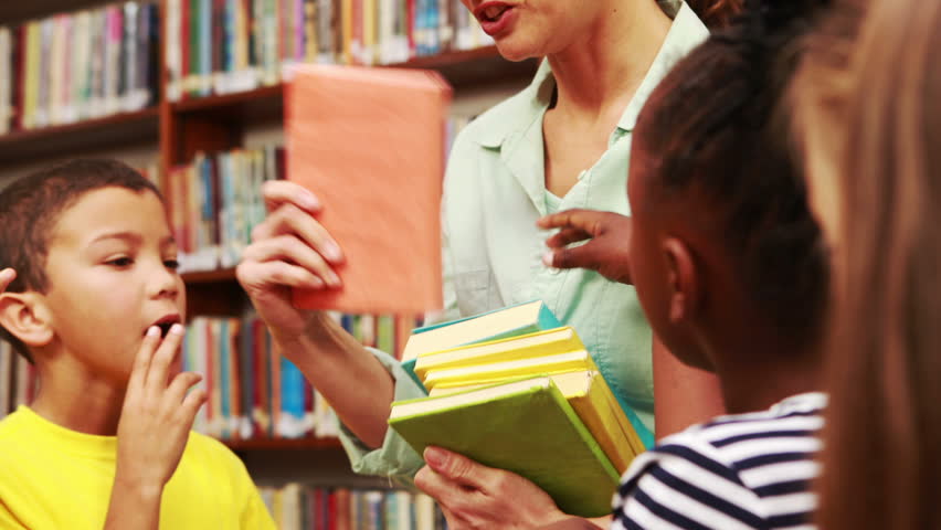 Teacher Passing Out Books In Library In High Quality 4k Format Stock ...