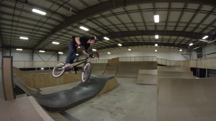 Extreme Sport Indoor Skateboard Park - BMX Bike Rider Doing Acrobatic ...
