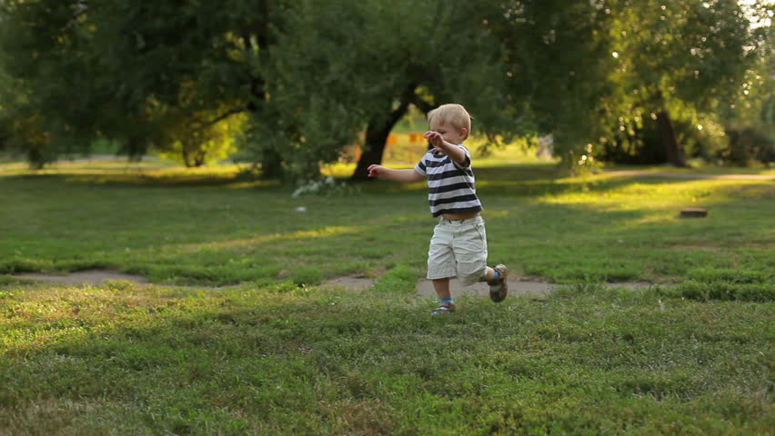 Cute Boy Running Away And Shooting With Toy Gun. Camera Motion ...