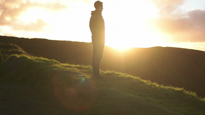 Young Caucasian Man Staring Into The Sunset While Seing Mountains And ...