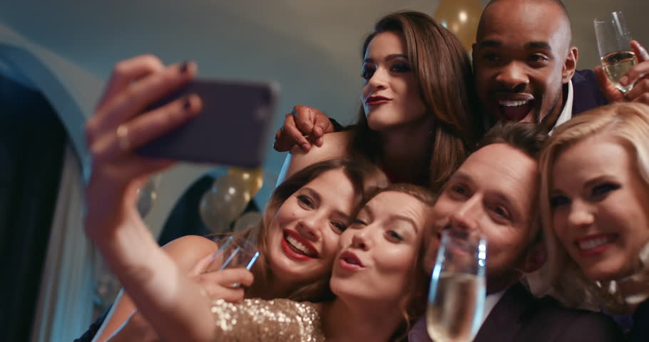Smiling Group Of Friends Celebrating Evening Event Taking Selfie At ...