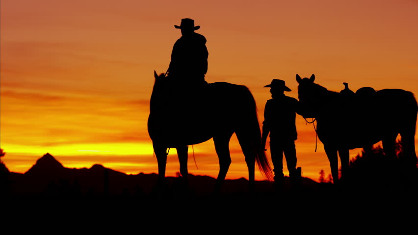 Silhouette Reveal Of Cowboy Riders In Sunset Wilderness Canada ...
