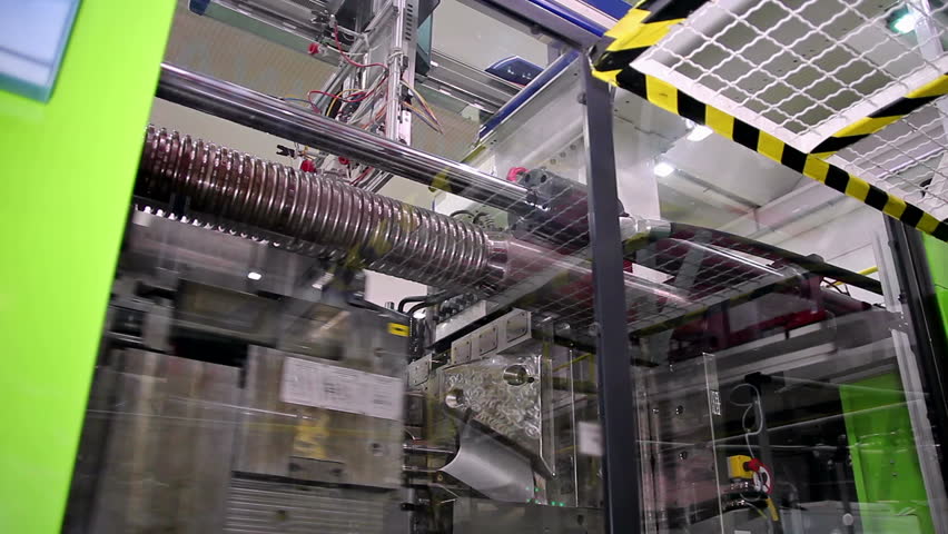 Automated Production Line.Robot Unloads Plastic Car Component From An ...