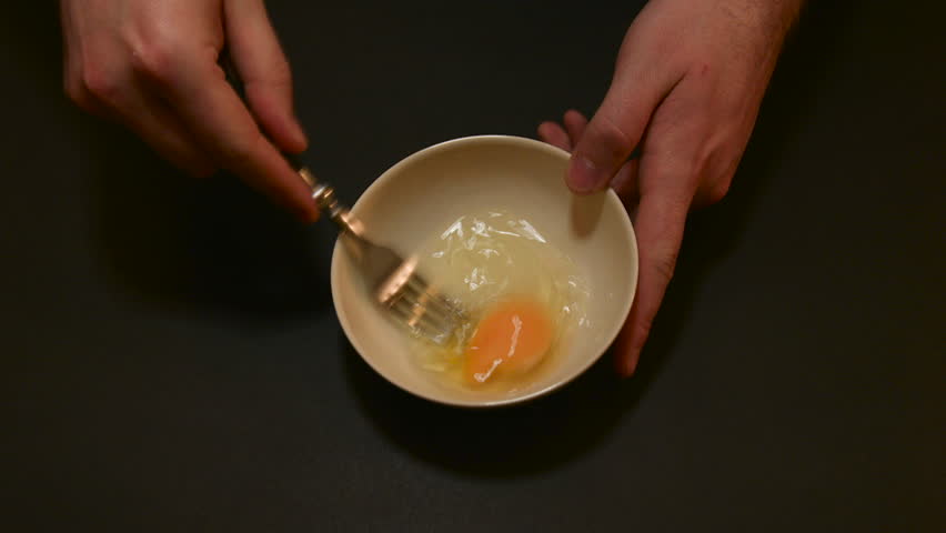 Hand Breaks An Egg Into The Bottle With One Hand, Mixing With A Fork In ...