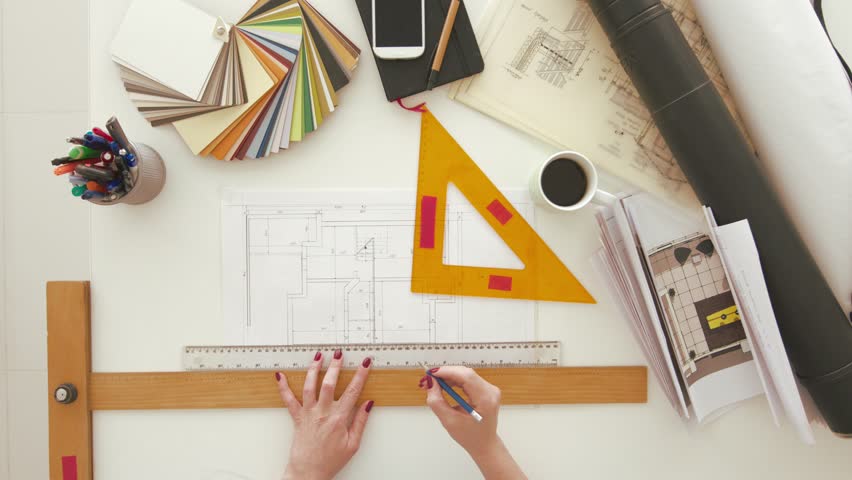 Female Architect Drawing On Blueprint Using Rulers. Top View Of Table ...