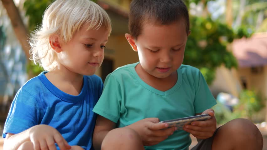 Stock Video Clip of Multiracial children playing online games on smart ...