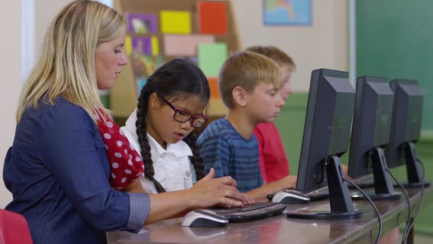 Elementary School Student And Teacher Look At Computer วิดีโอสต็อก ...