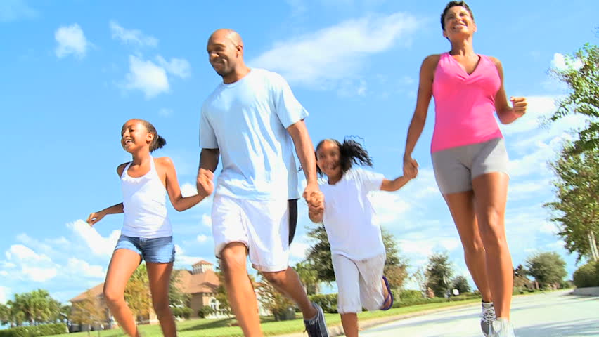 Energetic Young American Family Enjoying Healthy Outdoor Exercise ...