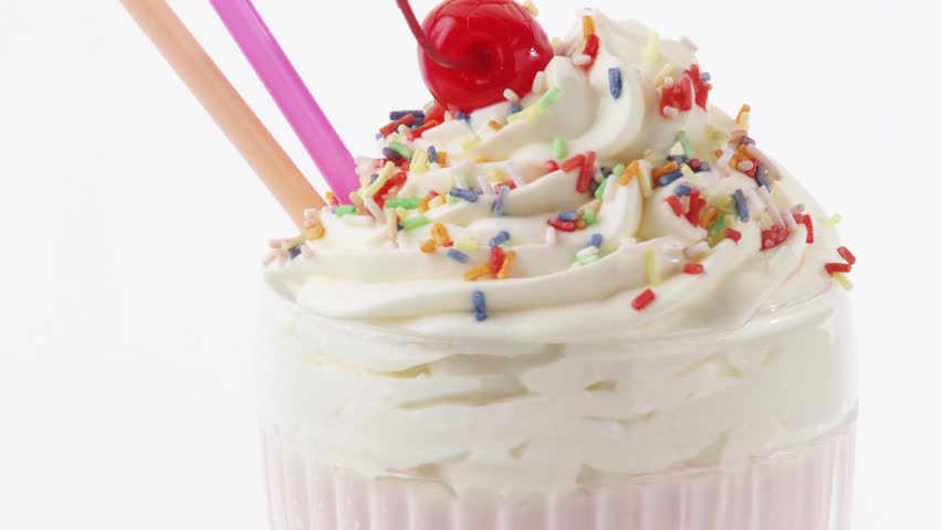 Stock video of milkshake with cream, sprinkles and cocktail | 2093585 ...