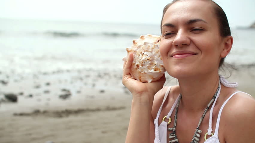 Attractive Woman Holding Shell And Listening The Sound Of The Sea ...