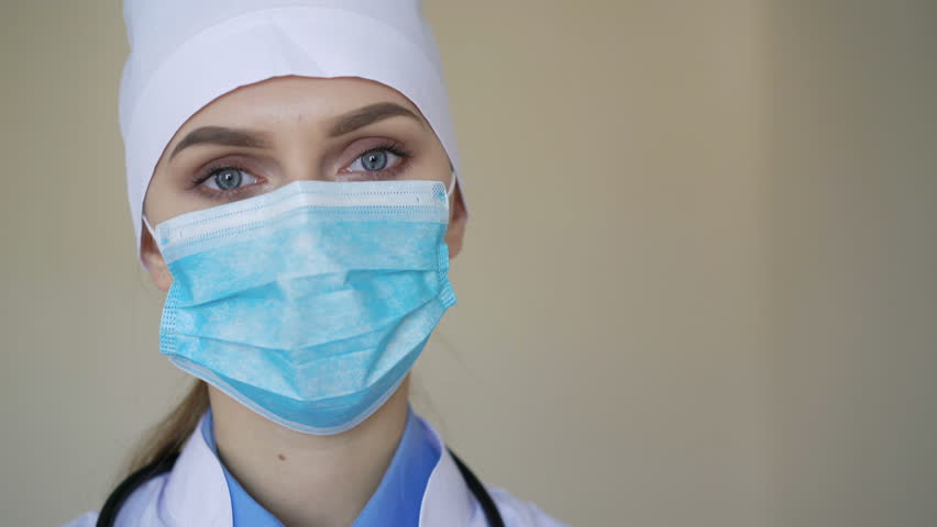 Stock video of female medical worker wearing face mask | 21414325 ...