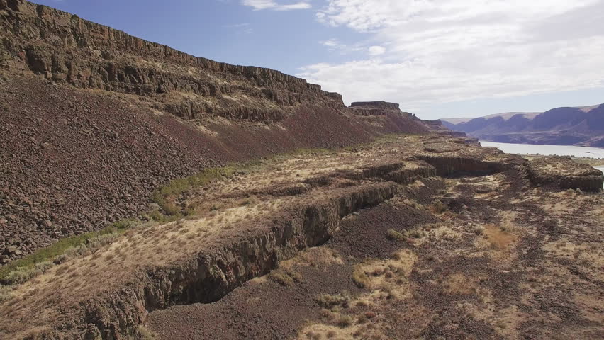 Aerial Shot Of Dry Desert Terrain With Large Rocky Brown Cliffs Stock ...