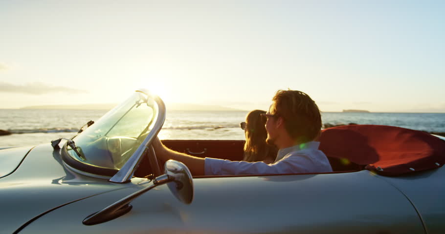 Romantic Couple Hands In Thr Air Driving In Vintage Convertible Car At ...
