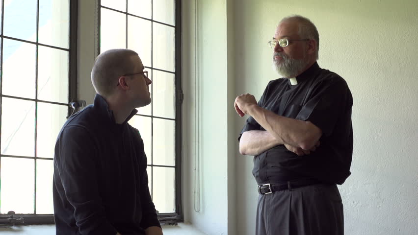 Stock Video Clip of Priest talking with parishioner in a church ...