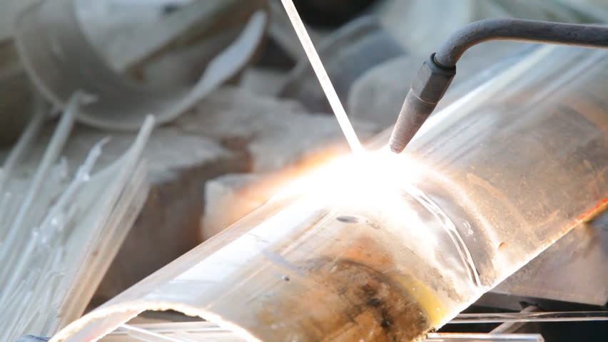 Close Up Of A Craftsman Welding Two Pieces Of Metal. Sparks Are Flying ...