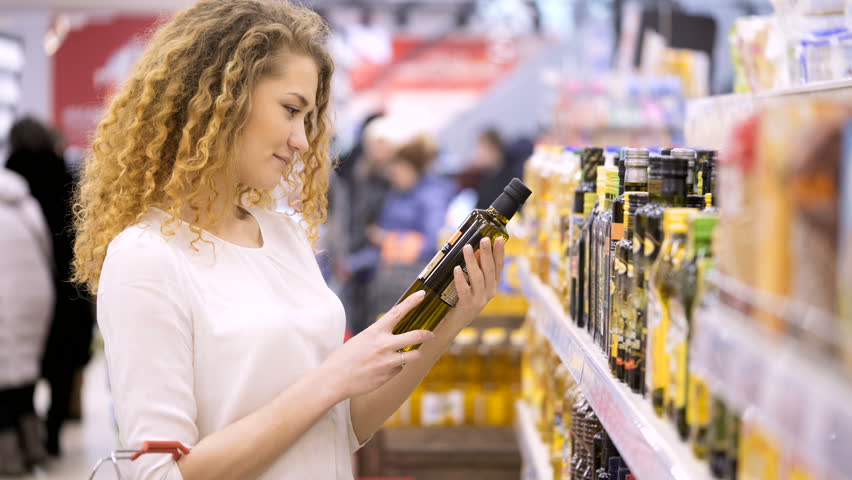 Stock video of woman chooses oil in the supermarket. | 25025135 ...