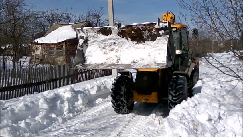 Bulldozer Pushing Deep Snow Off Mountain Road Near Forest In Central ...