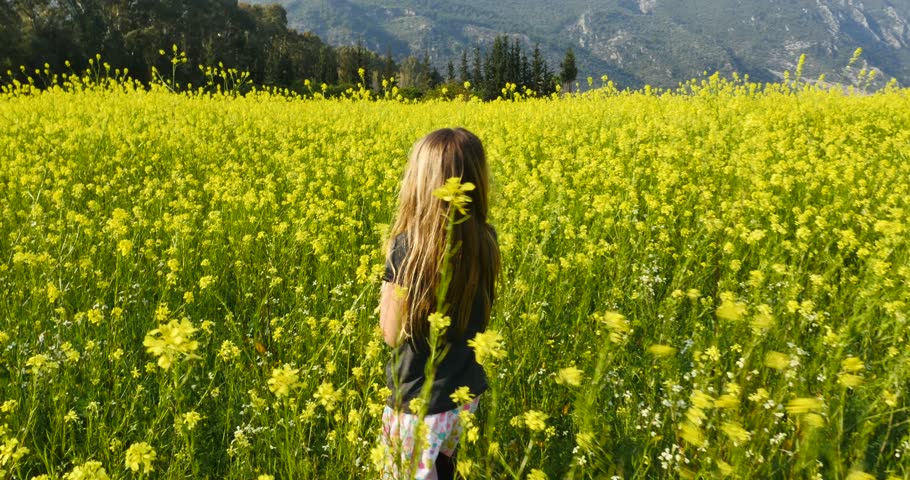 Happy Child Running Through A Meadow Of Yellow Flowers Stock Footage ...