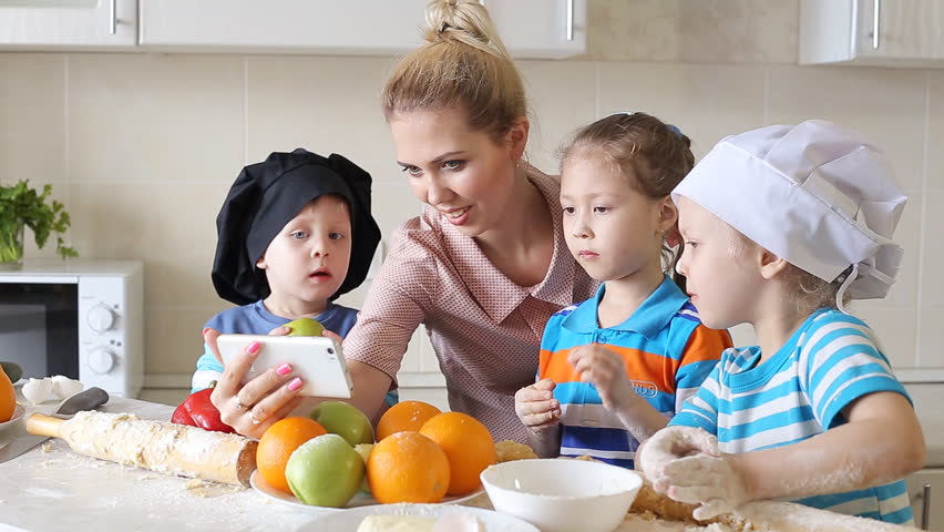 Little Chefs Learn To Cook. Mother With Children In The Kitchen. Stock ...