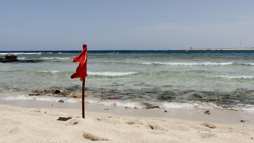 Stock video of signal red flag on the sand | 29250535 | Shutterstock