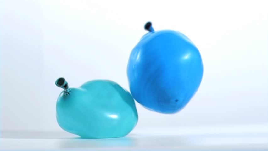 Blue Water Balloon Falling On Black Background In Slow Motion Stock ...