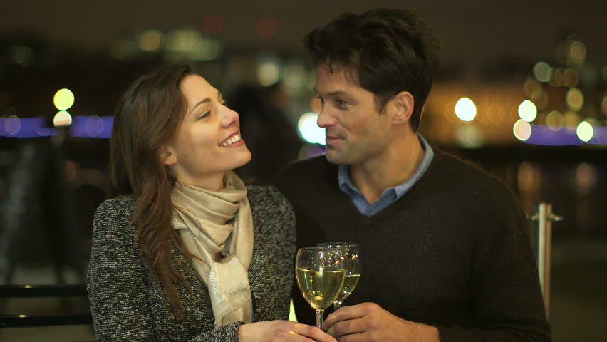 An Attractive Casually Dressed Couple Are Drinking Wine At An Open Air ...