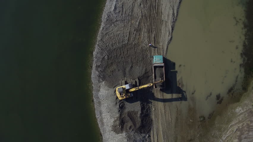 Yellow Dredge Scooping Sand In River And Loading Tipper On Sandbank ...