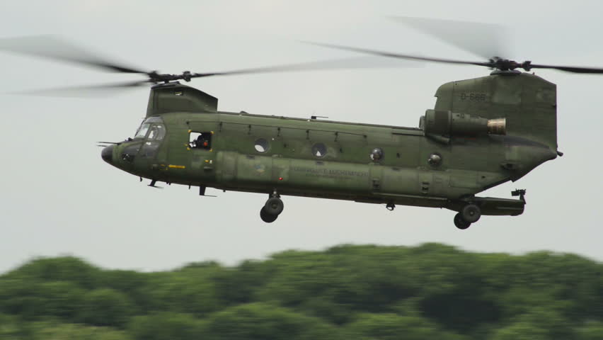 A Chinook CH-47 Helicopter Fly By With An Apache AH-64 In The ...
