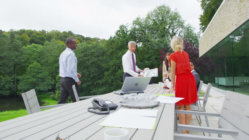 Stock Video Clip of Diverse business group in outdoor meeting outside ...