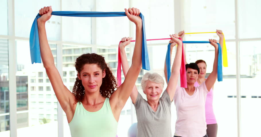 Stock Video Clip of Women stretching resitance bands at a fitness ...