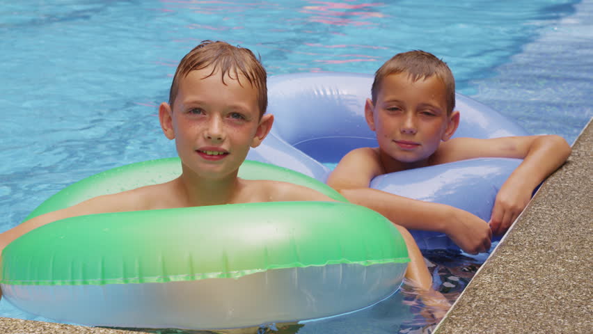 Boy In Pool Swimming With Innertube. Shot On RED EPIC For High Quality ...