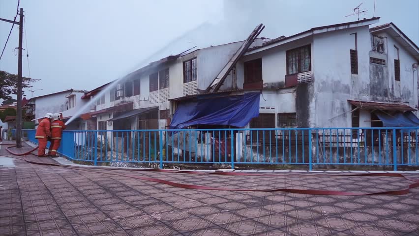 Stock Video Clip of KUALA LUMPUR-FEBRUARY 12: Firefighters extinguish a ...