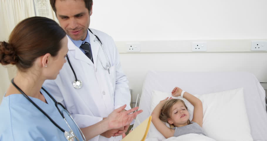 Little Sick Boy Sitting In Bed Talking With Doctor In The Hospital Ward ...