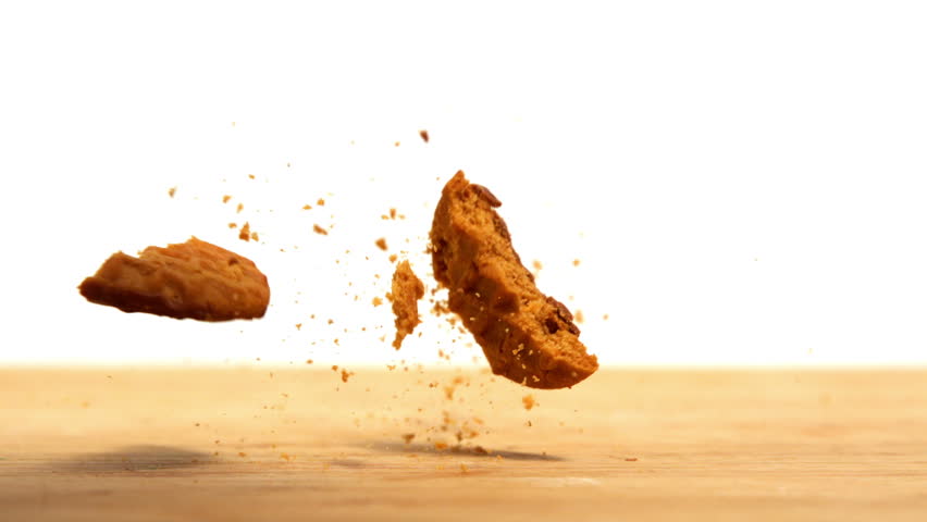 Stock Video Clip of Biscuit falling and breaking on wooden table ...
