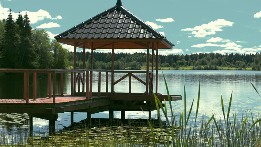 Two Lovely Bamboo Huts On Stilts Stand Over A Pond Near A Marsh In ...