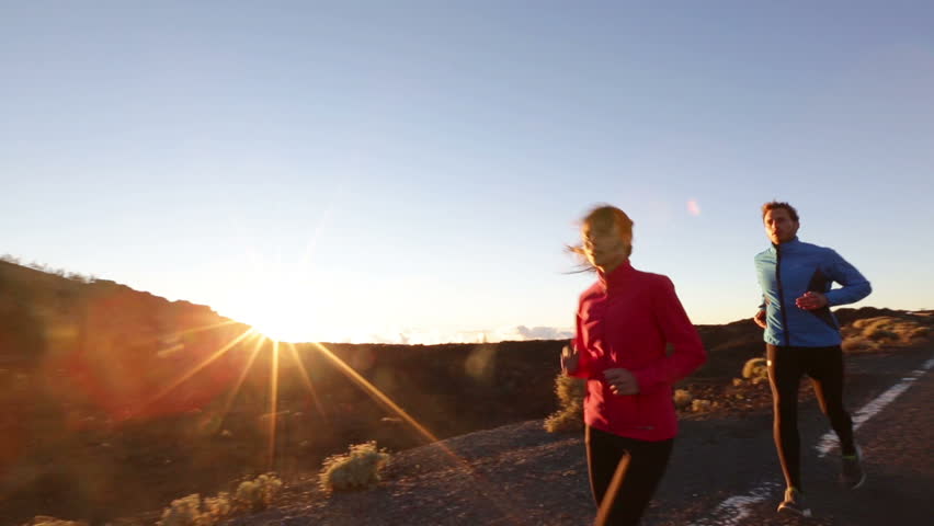 Running Sport Athletes Woman And Man Jogging At Night Sunset. Runners ...
